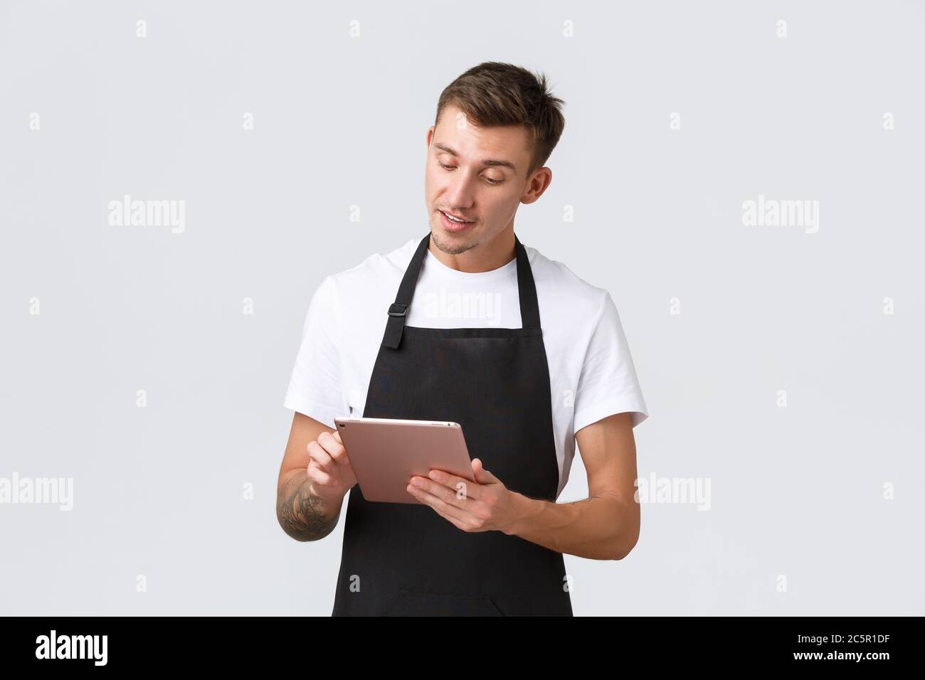 Small business, coffee shop and cafe employees concept. Handsome young ...