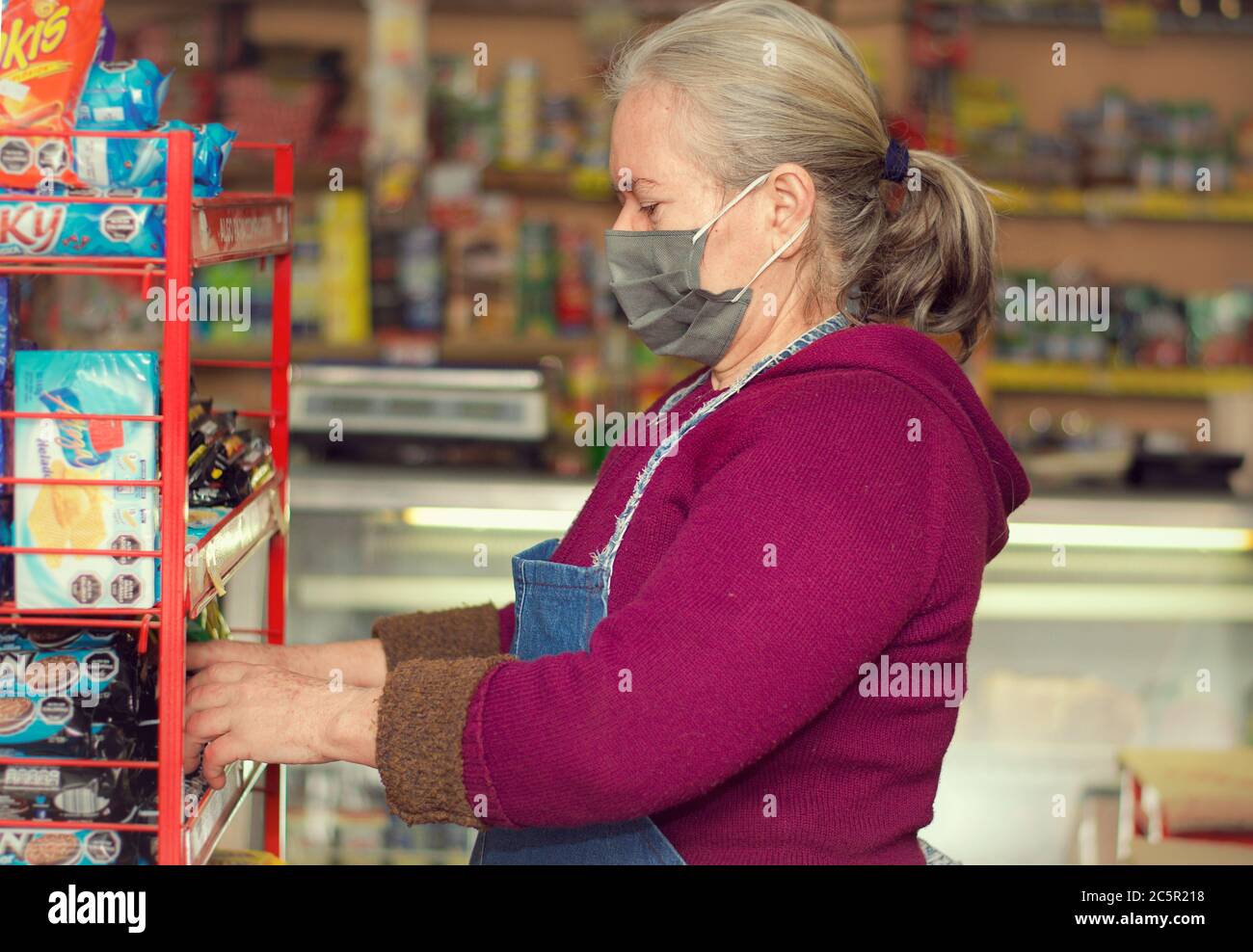 Woman owner of small grocery store Stock Photo - Alamy