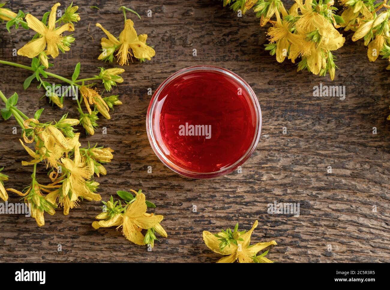 Red oil made from St. John's wort flowers in a bowl, top view Stock ...