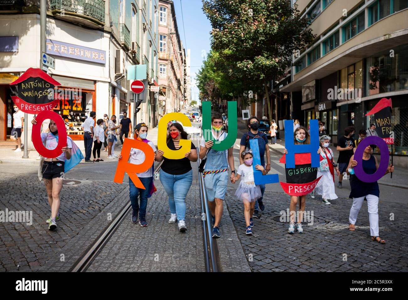 Participants hold vocals saying orgulho meaning pride during the parade ...