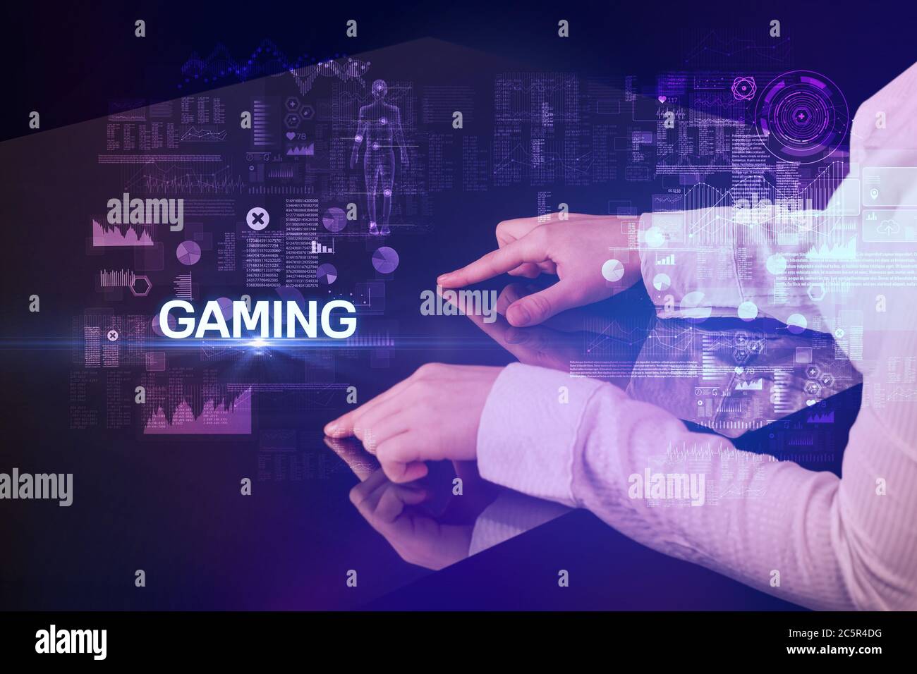 Businessman touching huge display with GAMING inscription, modern ...