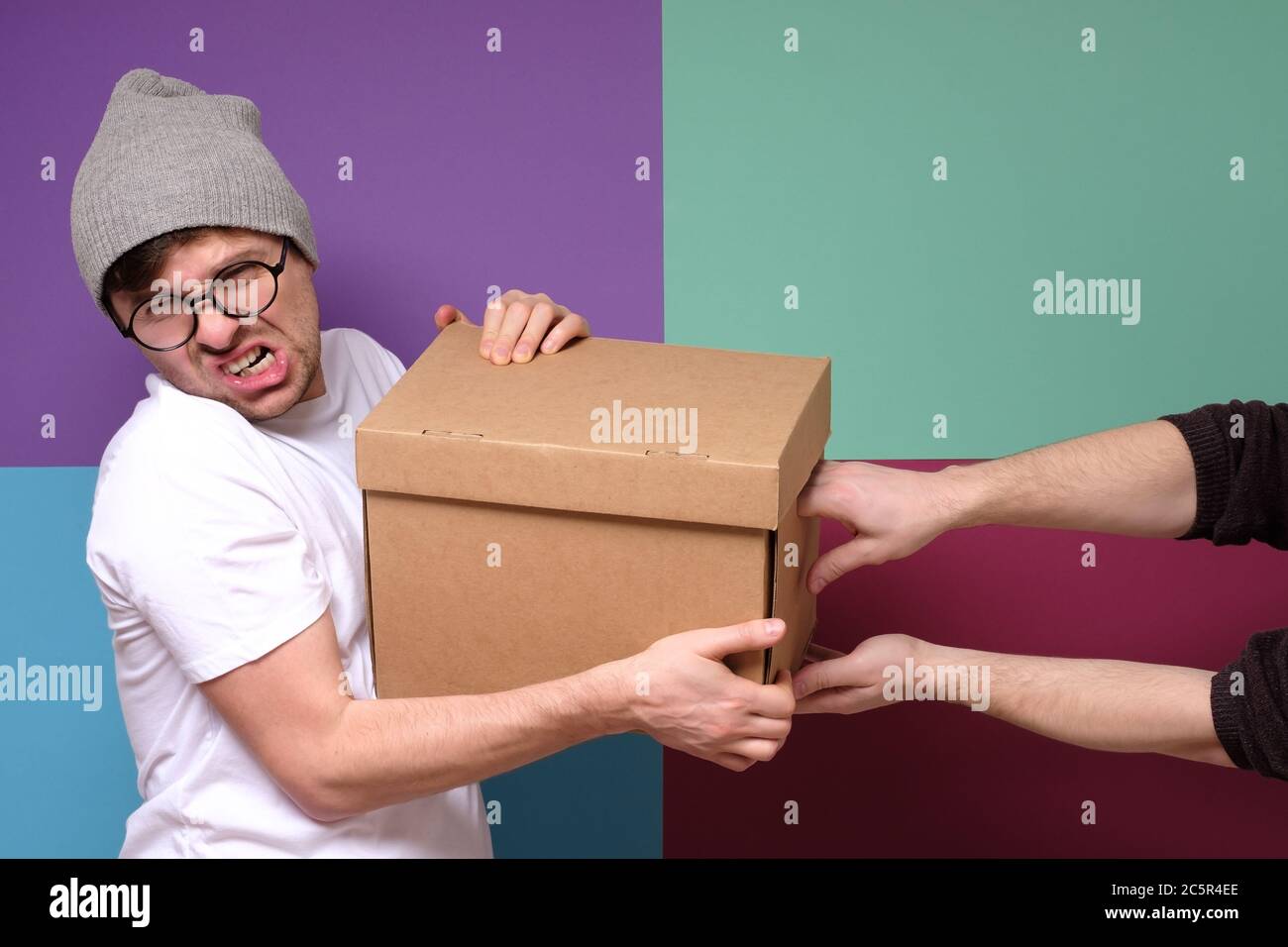 Fight between two men for a box Stock Photo - Alamy