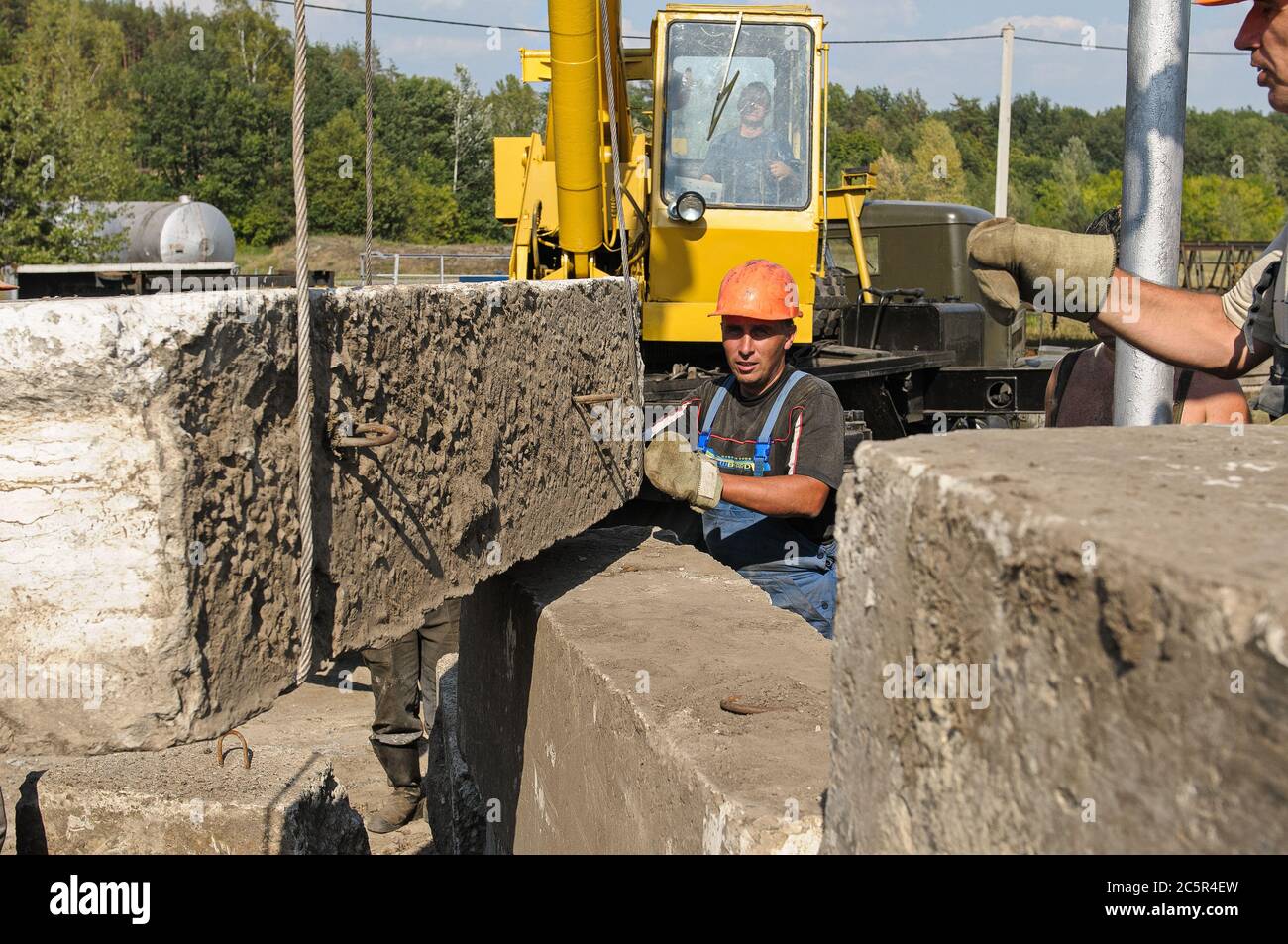 Preparation of a gas well for overhaul. Workers are installing concrete ...