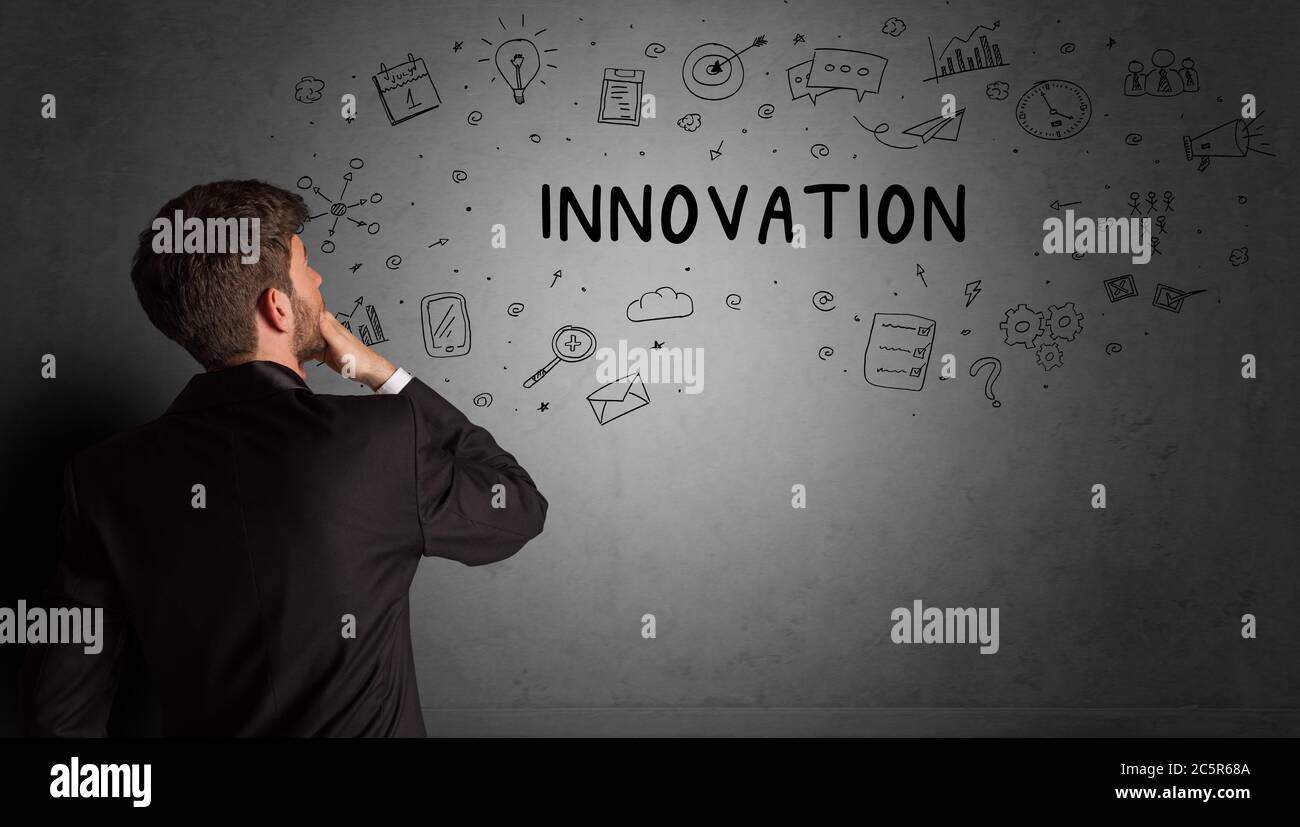 businessman drawing a creative idea sketch with INNOVATION inscription ...