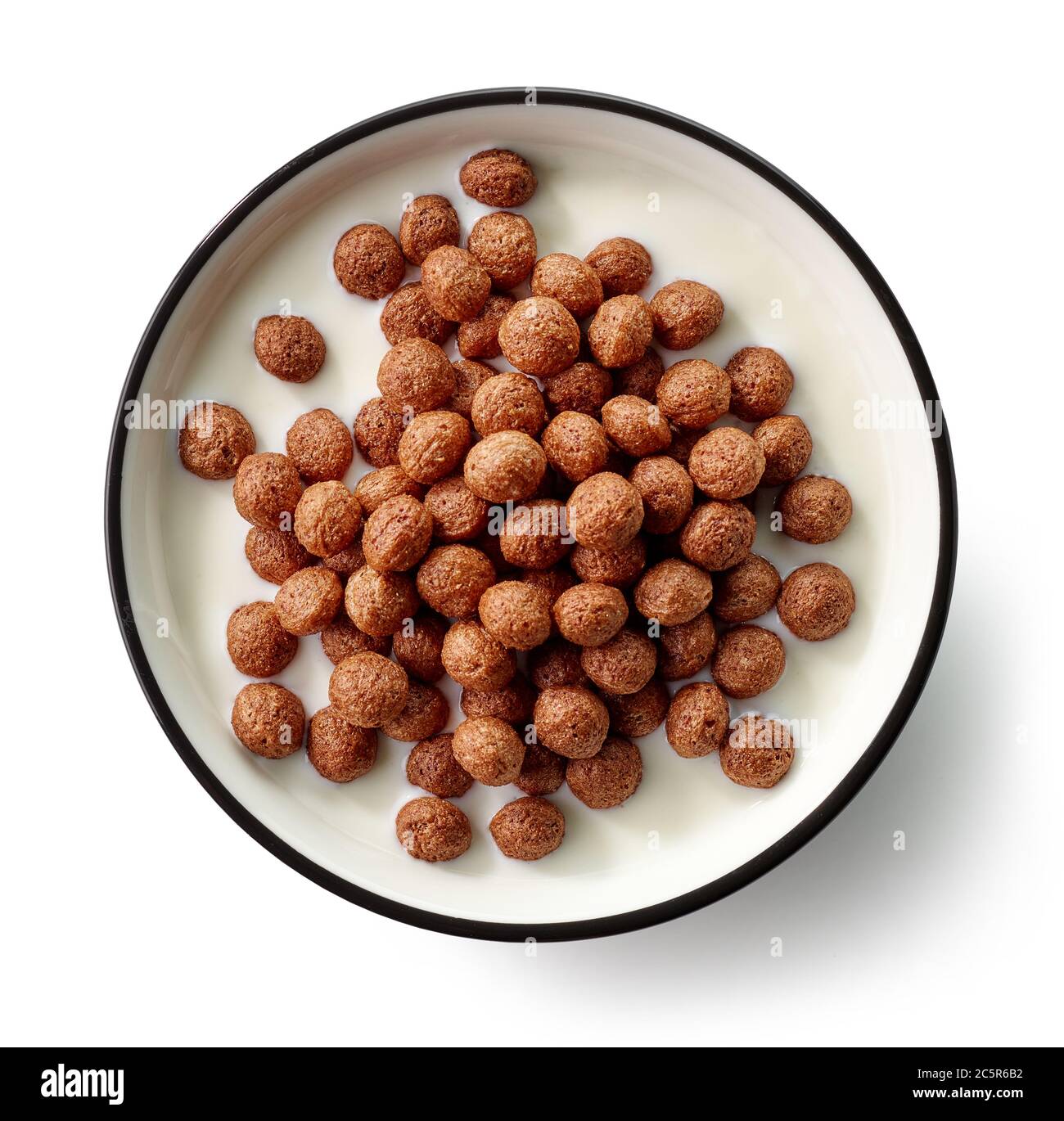 bowl of chocolate breakfast balls with milk isolated on white ...