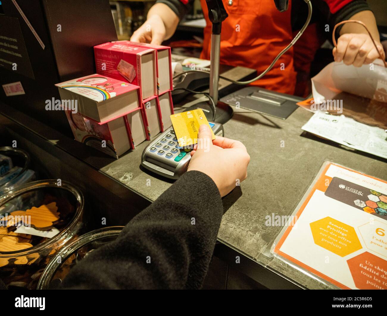 Paris, France - Dec 9, 2017: Woman paying Contactless at the shop ...