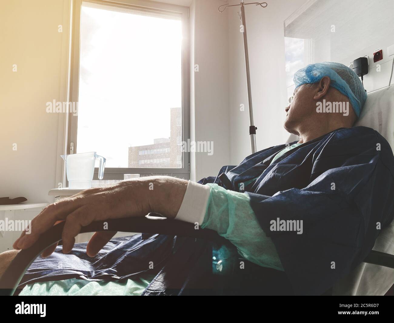 Lying on the medical chair senior male inside modern hospital in France ...