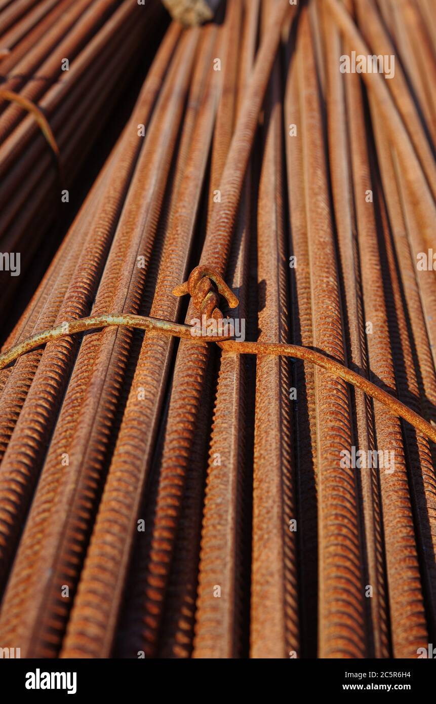 Stack of rusty bars tied with iron knot Stock Photo - Alamy