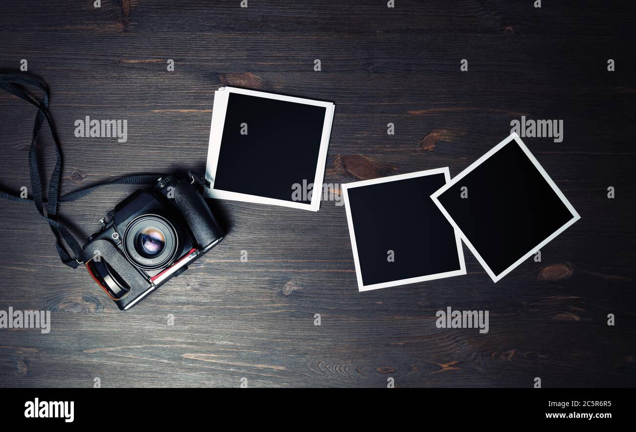 Vintage camera and blank square photo frames on vintage wooden ...