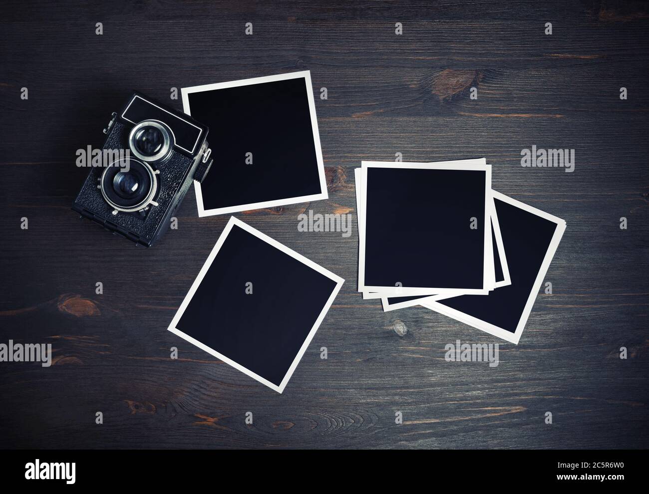Blank photos and vintage camera on wooden background. Square photo ...