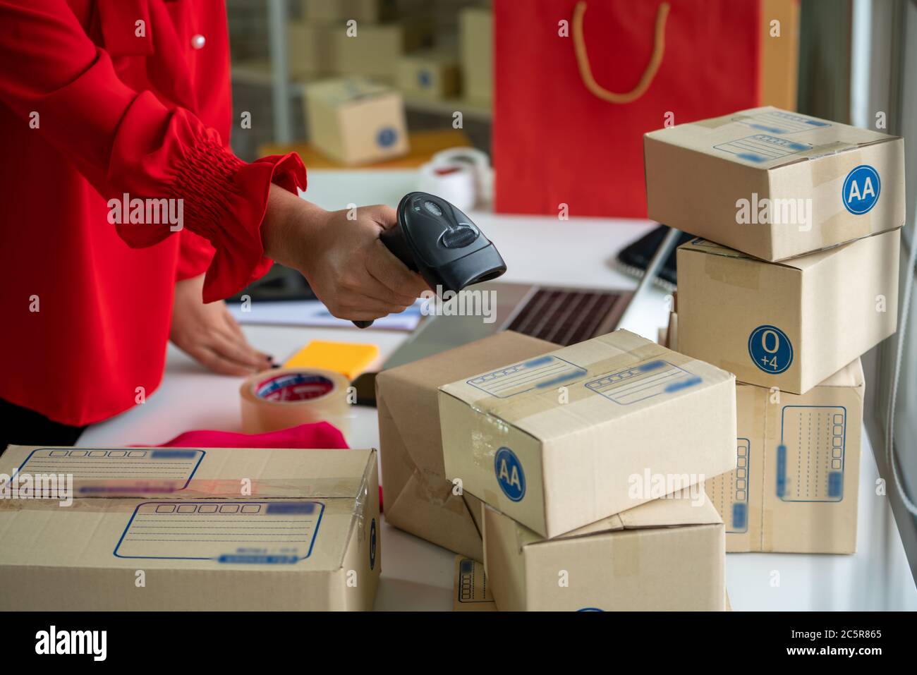 Online seller works at home office and packs shipping delivery box to ...