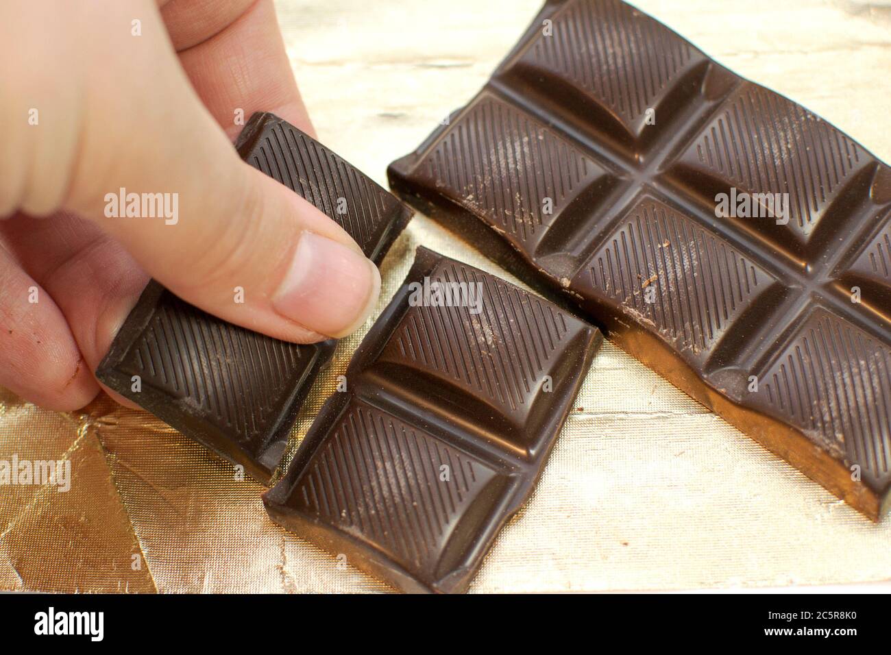 Dark chocolate candy bar on gold foil Stock Photo - Alamy