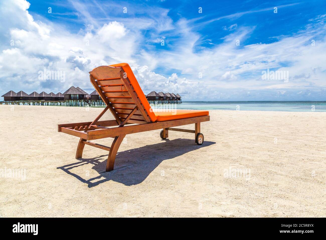 MALDIVES - JUNE 24, 2018: Wooden sunbed on tropical beach in the ...