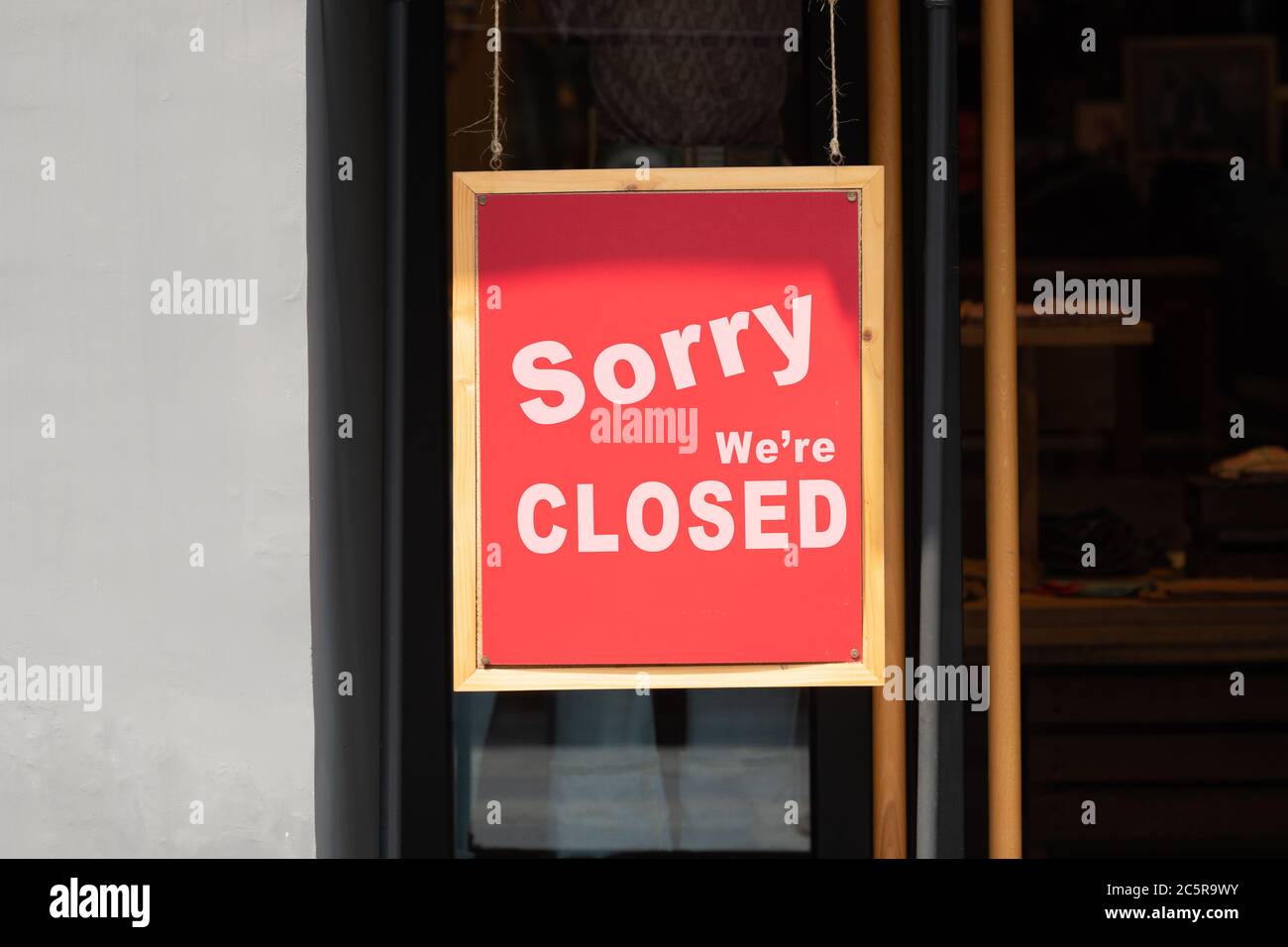 sorry we are closed sign hanging outside a restaurant, store, office or ...