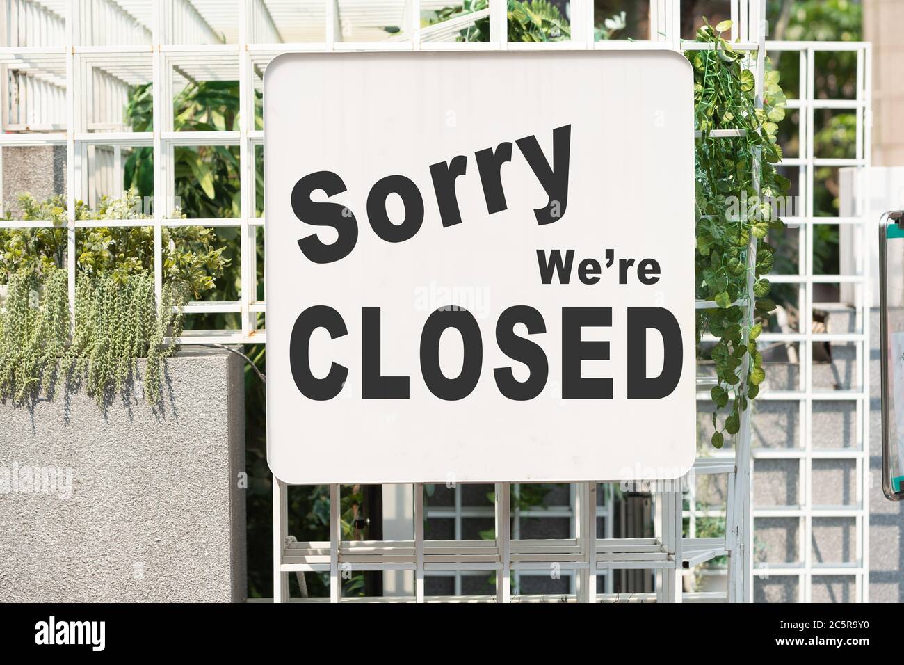 sorry we are closed sign hanging outside a restaurant, store, office or ...