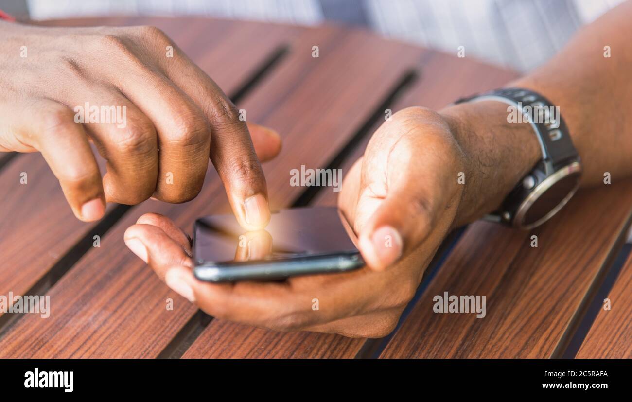 Happy Asian hand black man person holding a modern smart phone and ...