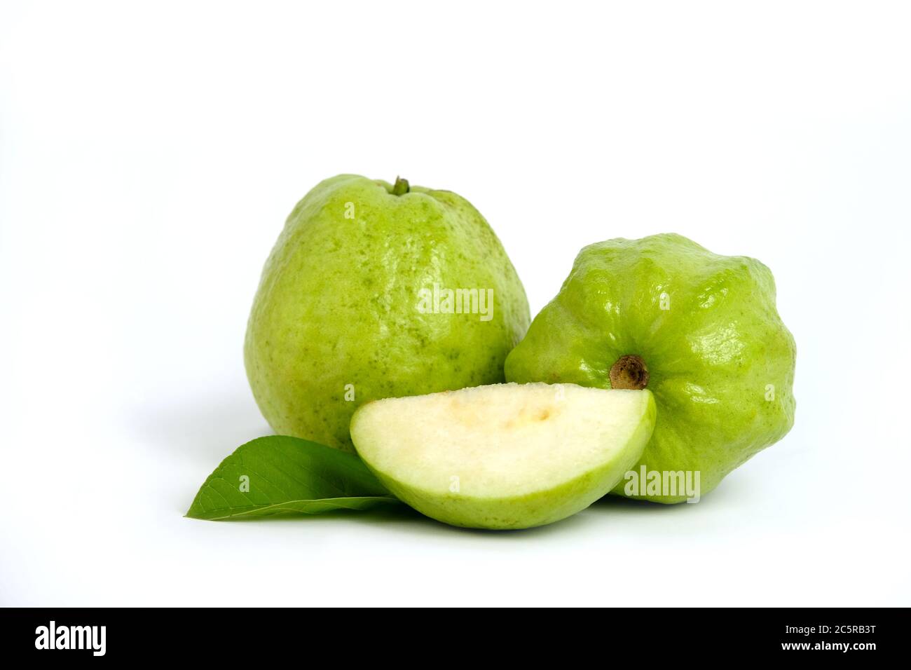 Green crystal guava raw fruit and sliced with leaves isolated on a ...