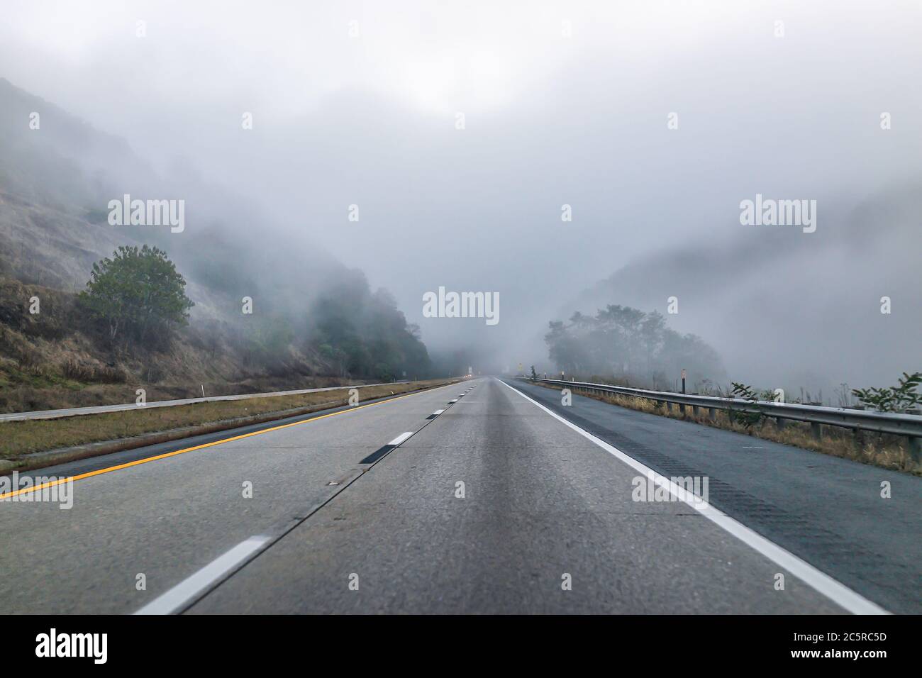 Fog mist road highway driving pov point of view in rural countryside in ...