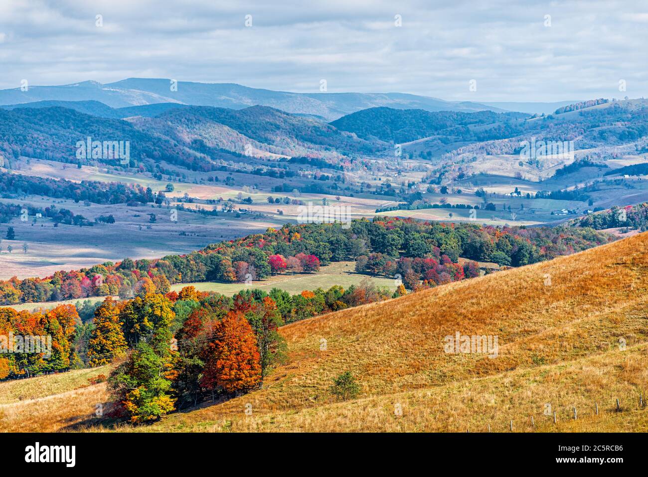 Autumn fall red colorful maple trees and farm land rolling hills aerial ...