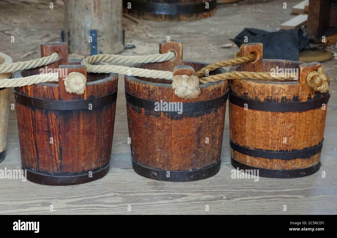 Three wooden barrel attached with ropes on the floor Stock Photo - Alamy