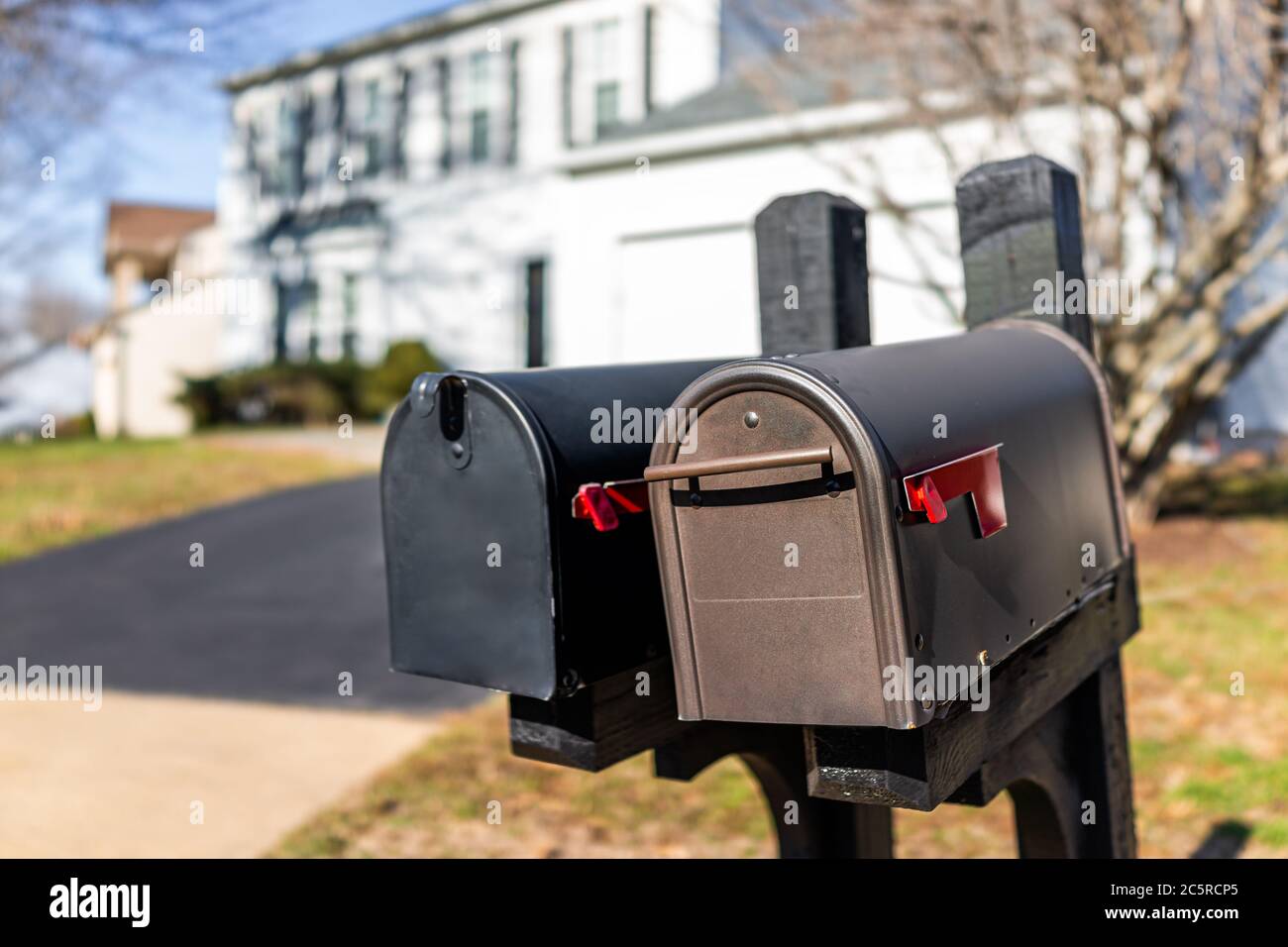 Closeup of two modern black and brown metal red flag mailboxes at ...
