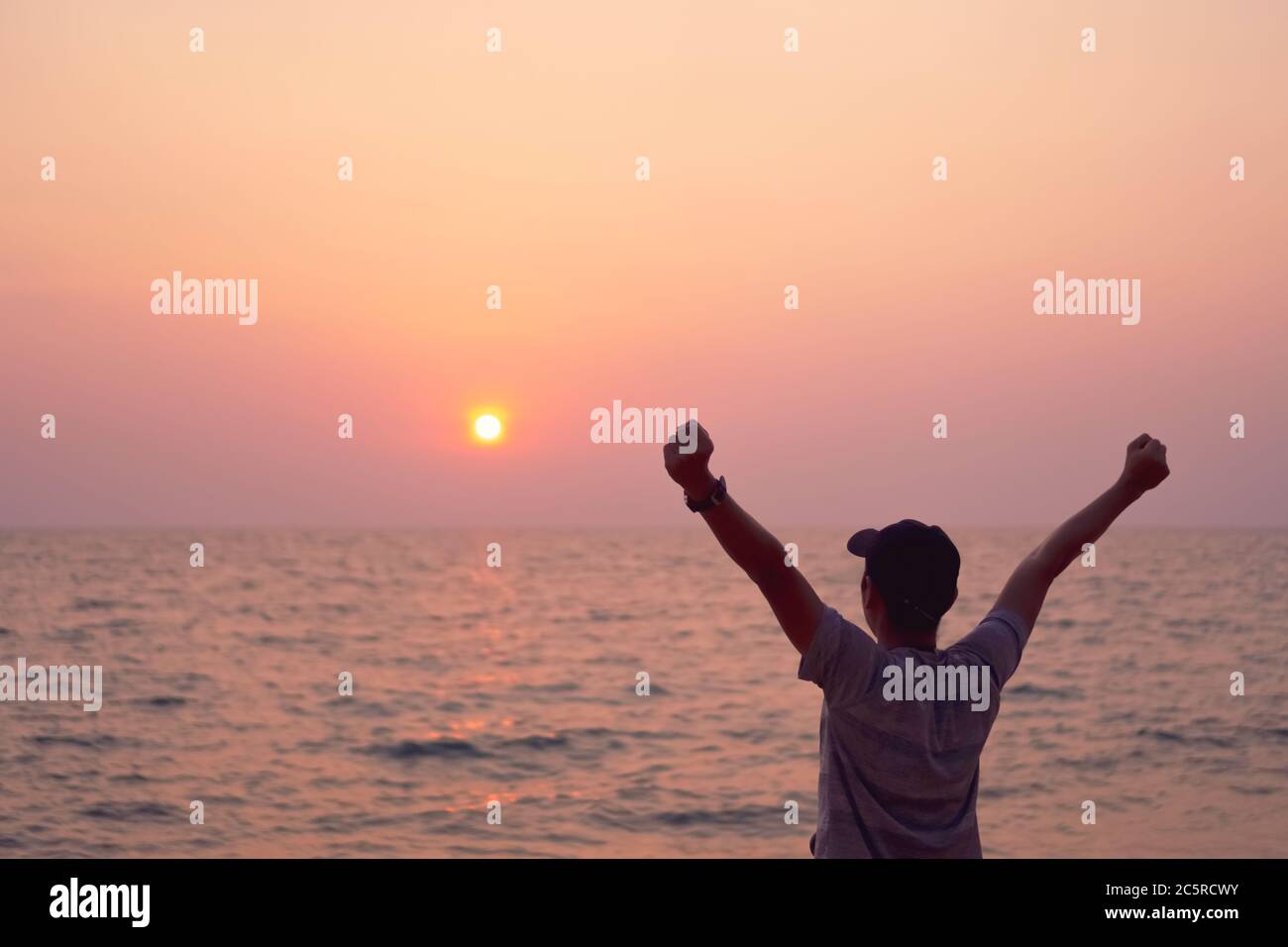 Man rise hands up to sky freedom concept with sunset sky and summer ...