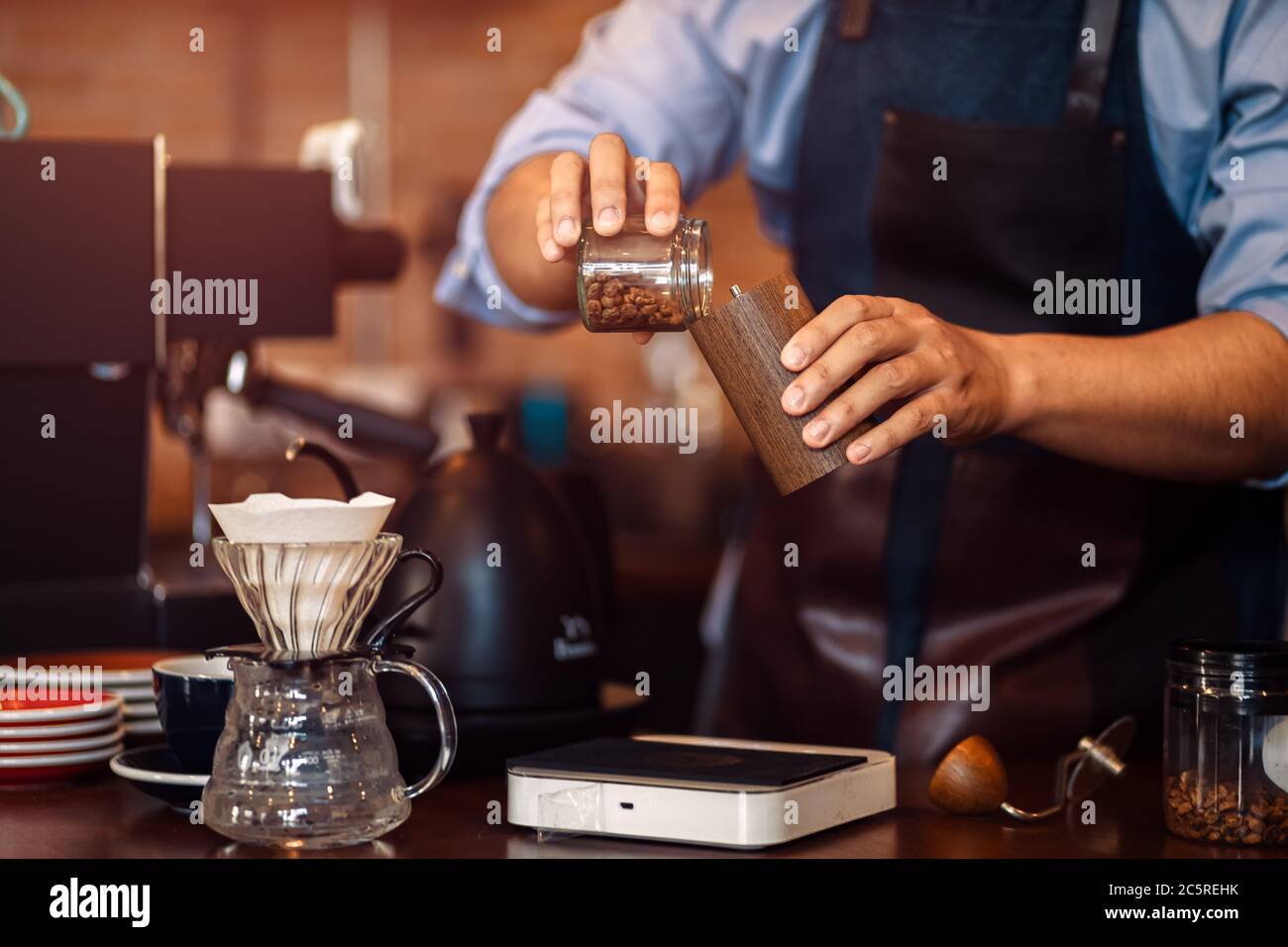 the barista hands on manual grinder coffee for grinding coffee beans at cafe Stock Photo - Alamy