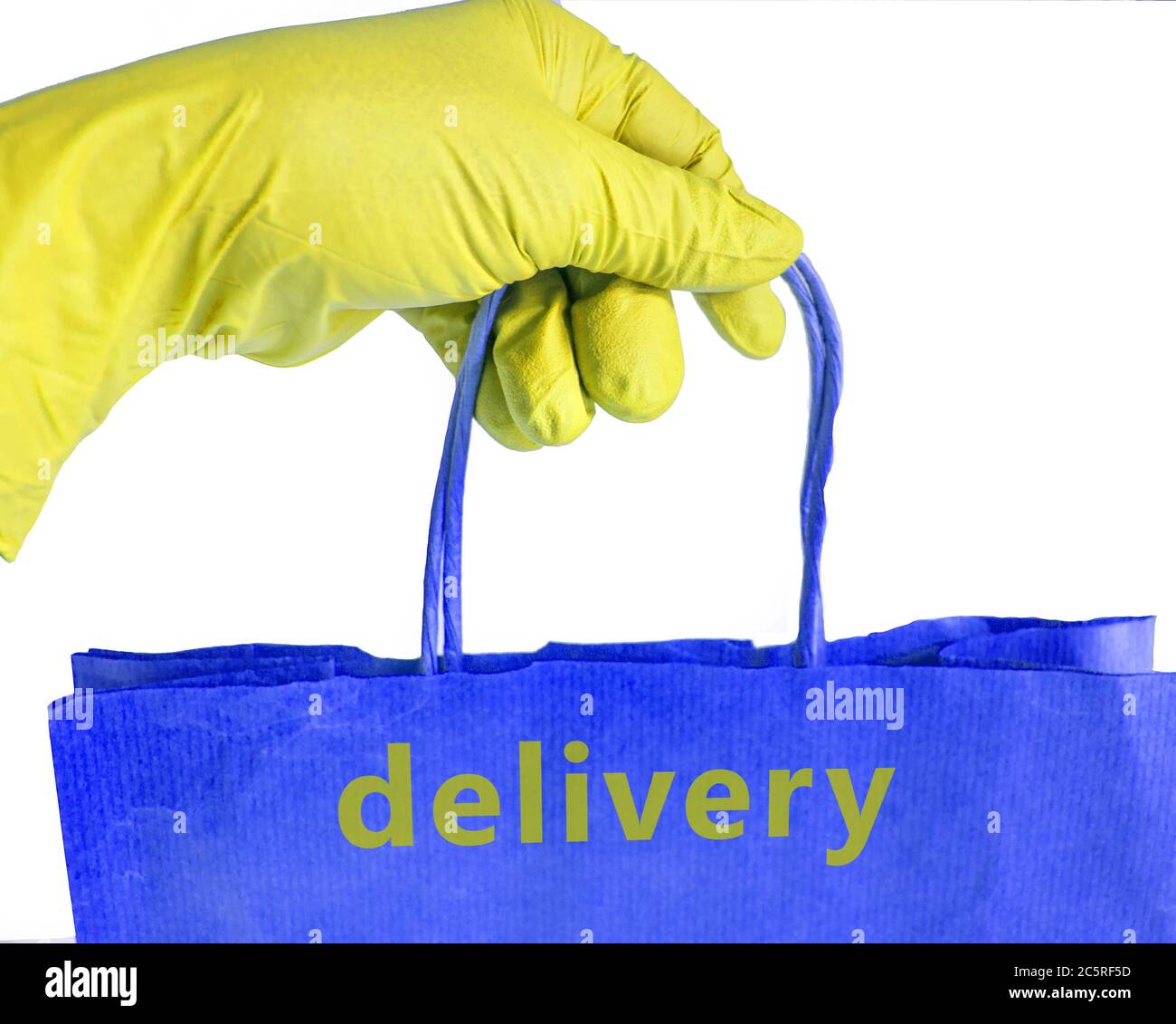 A hand in a yellow rubber glove holds a blue paper bag labeled DELIVERY ...
