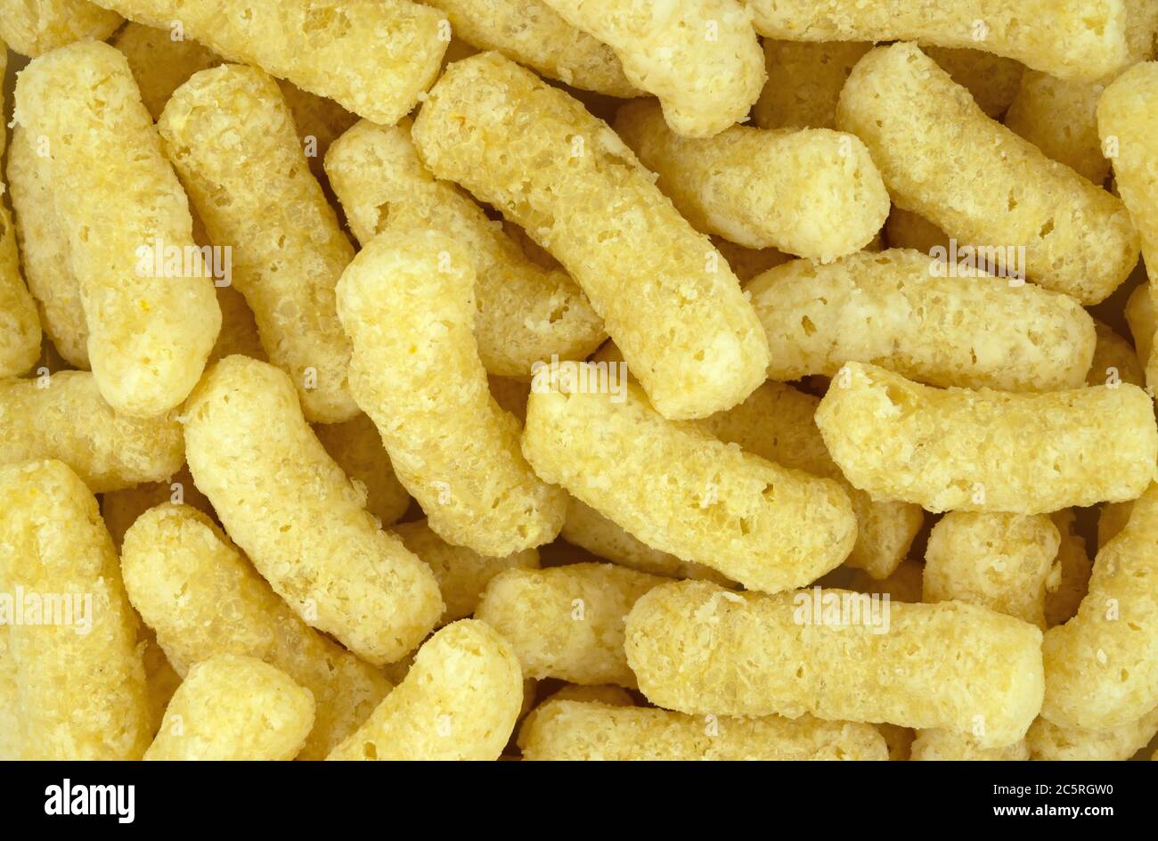 Air corn sticks with powdered sugar as a background Stock Photo - Alamy
