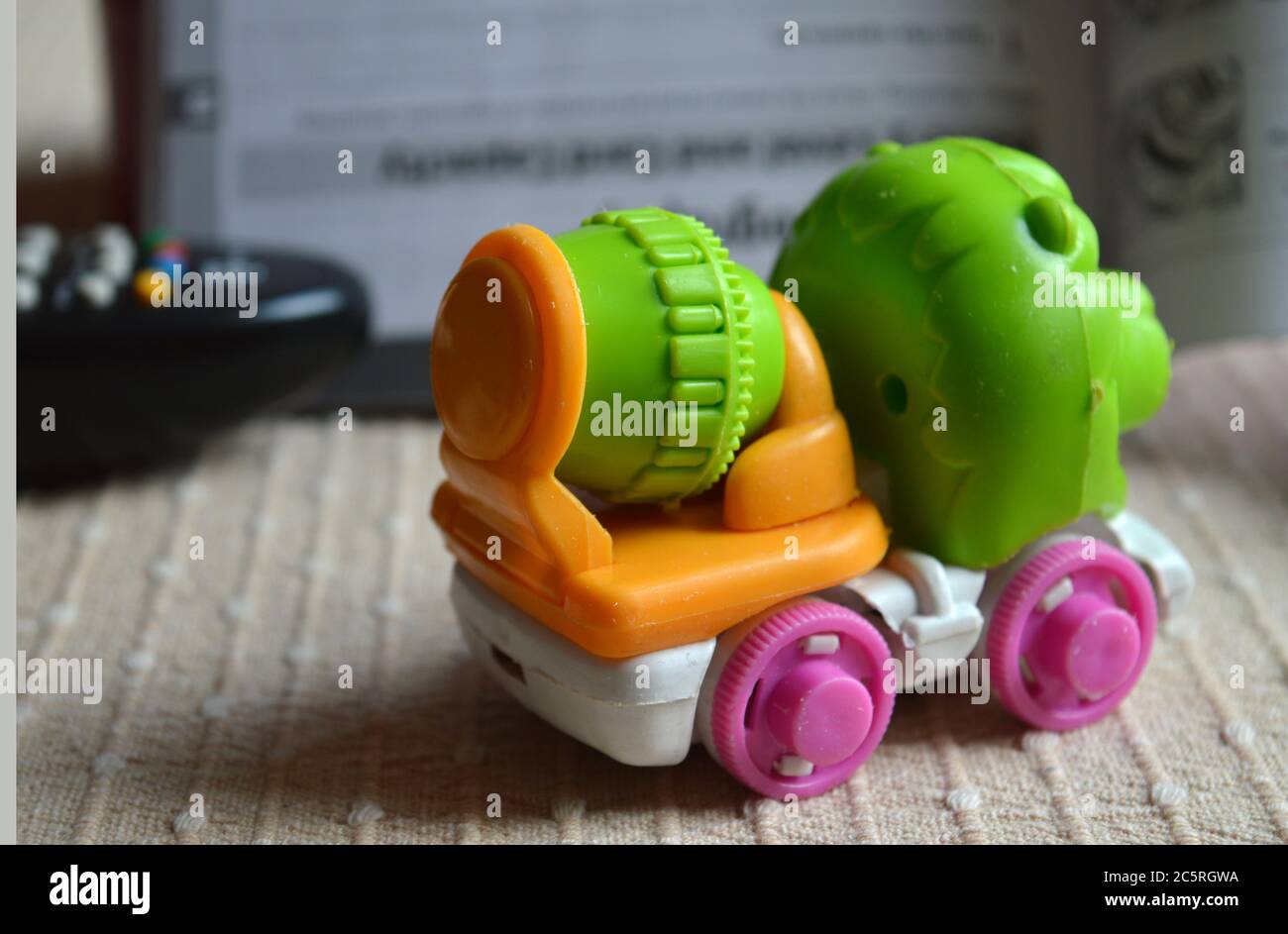 Plastic car toy on texture background Stock Photo - Alamy