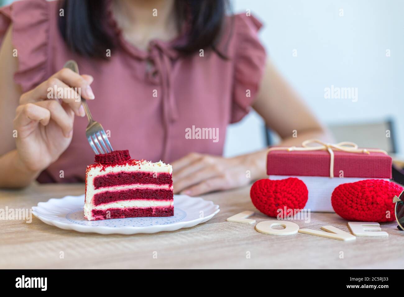eating Red Velvet strawberry cheese cake Stock Photo - Alamy