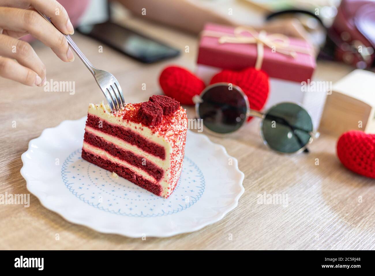 eating Red Velvet strawberry cheese cake Stock Photo - Alamy