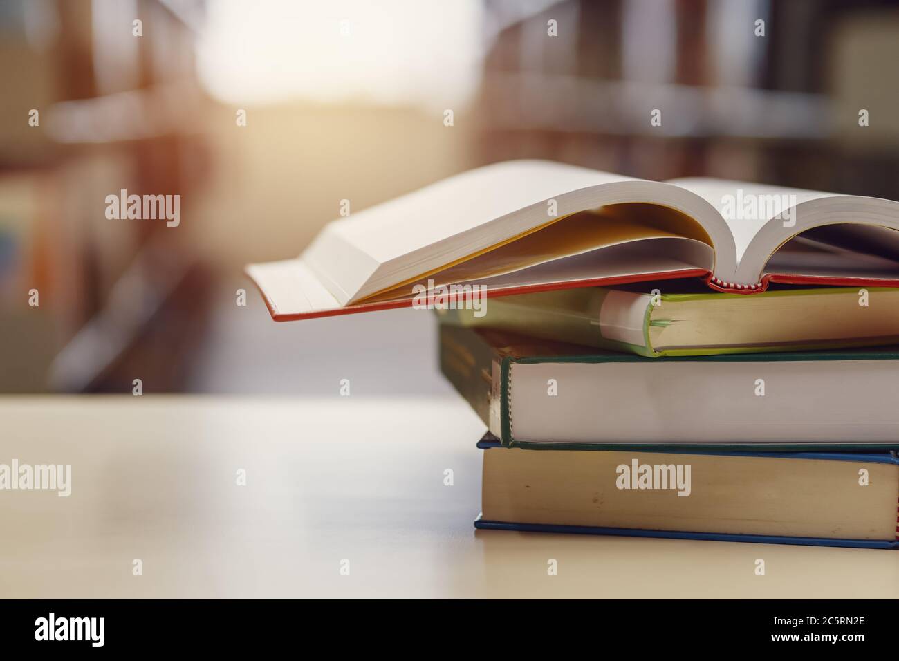 Open book on stack of books in library at school, university, college ...
