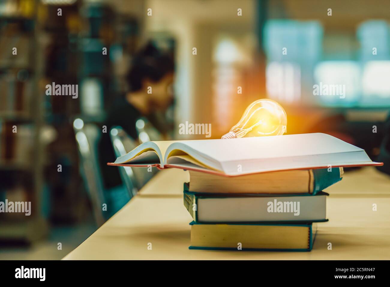 Open book on stack of books in library at school, university, college ...