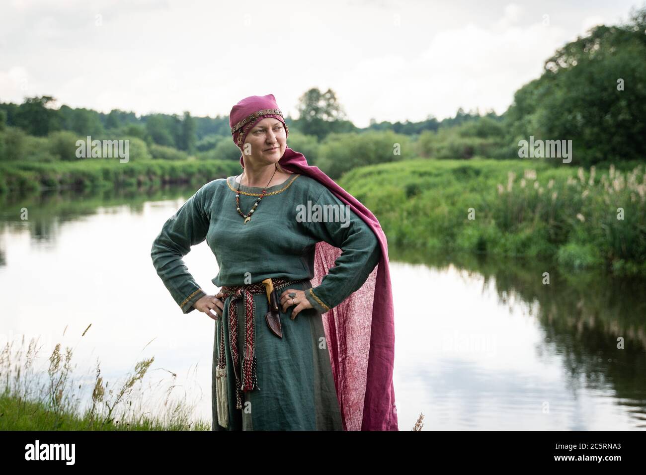 Expedition of live history lovers. A woman in ancient clothes of the ...