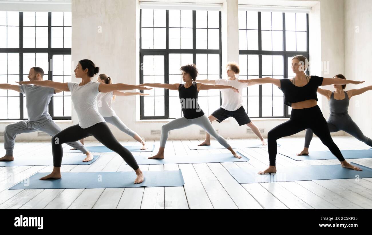 Young mixed race people standing in warrior II second position Stock ...