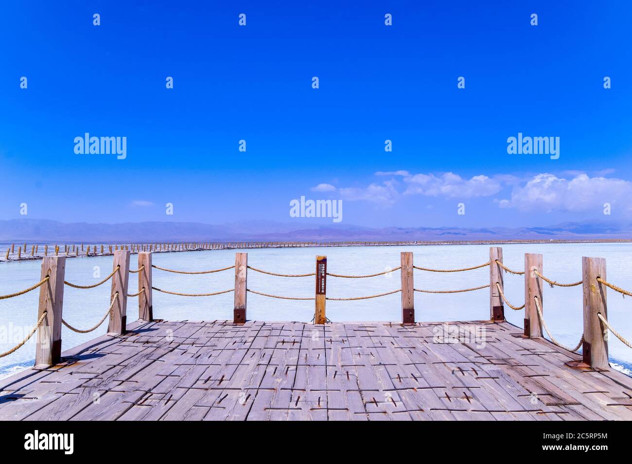 Over the vast salt lake, there are long wooden sidewalks. The beautiful ...