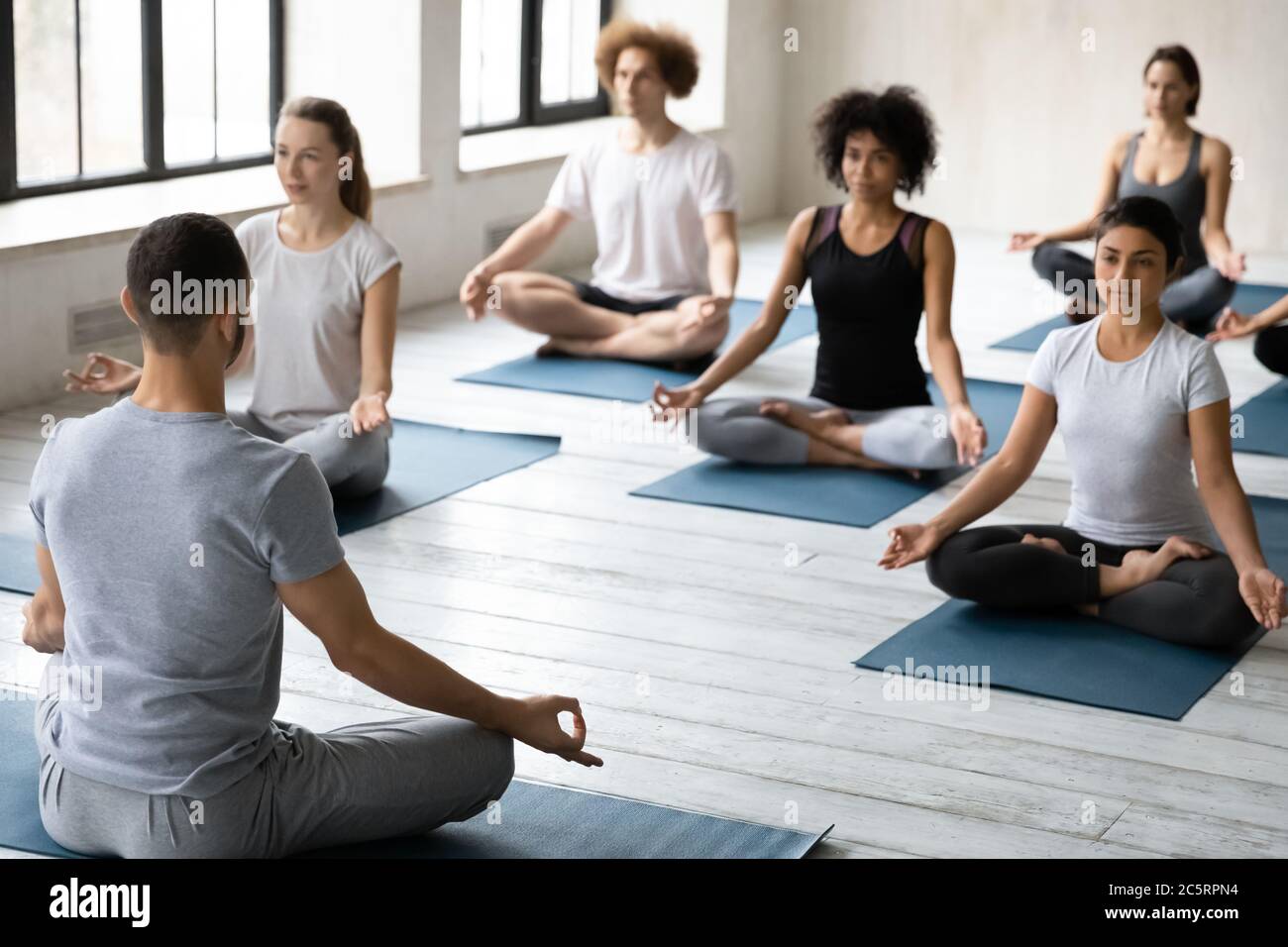 Young male instructor leading master class for multiracial people ...