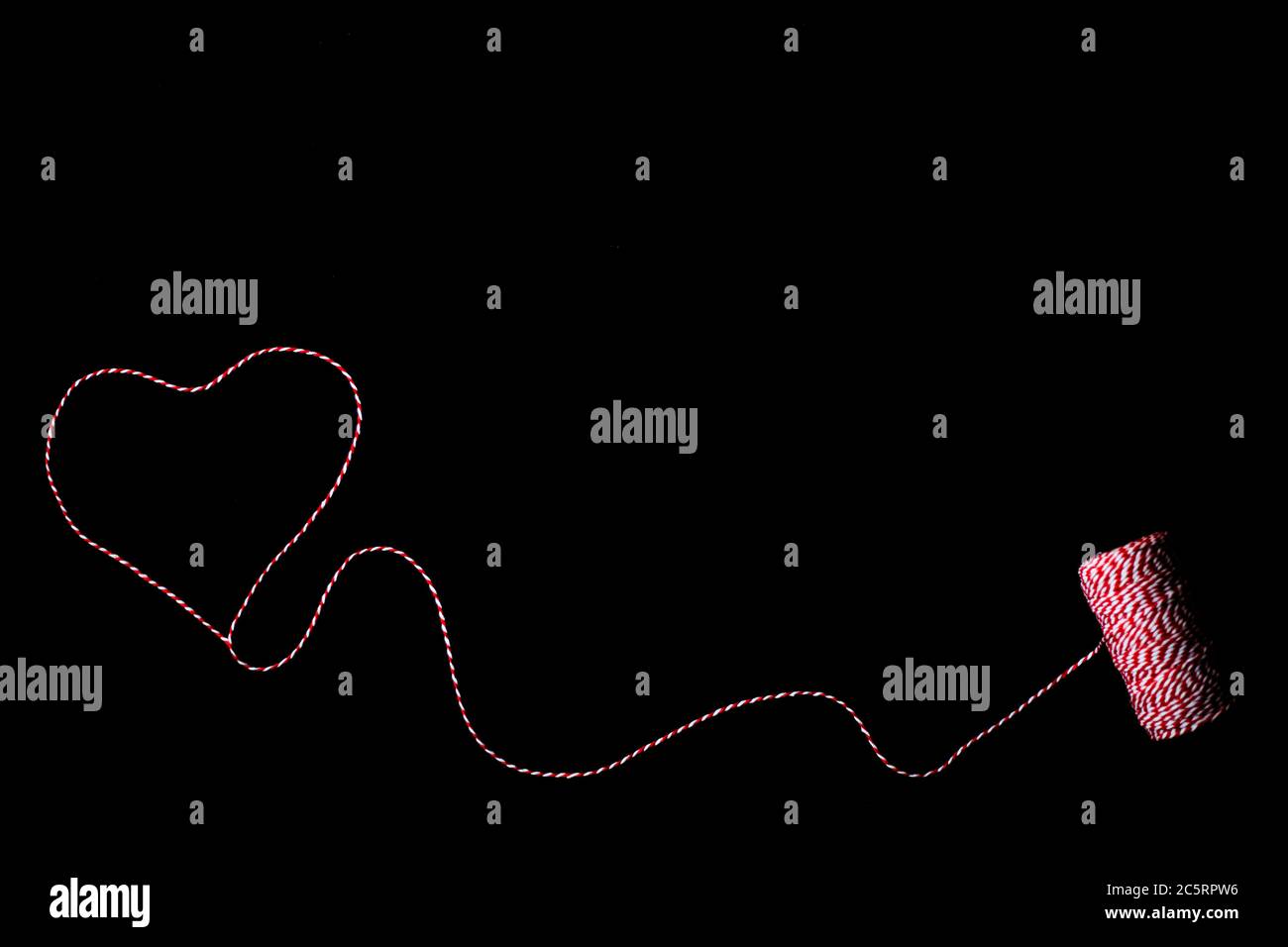 Rope wrap make heart shape and black background Stock Photo - Alamy