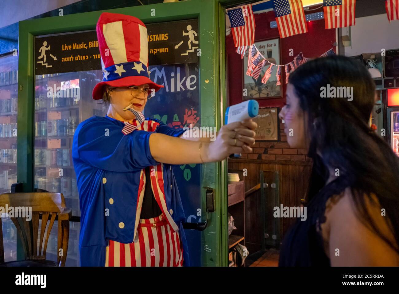 An Israeli woman dressed in a particularly patriotic Uncle Sam outfit ...