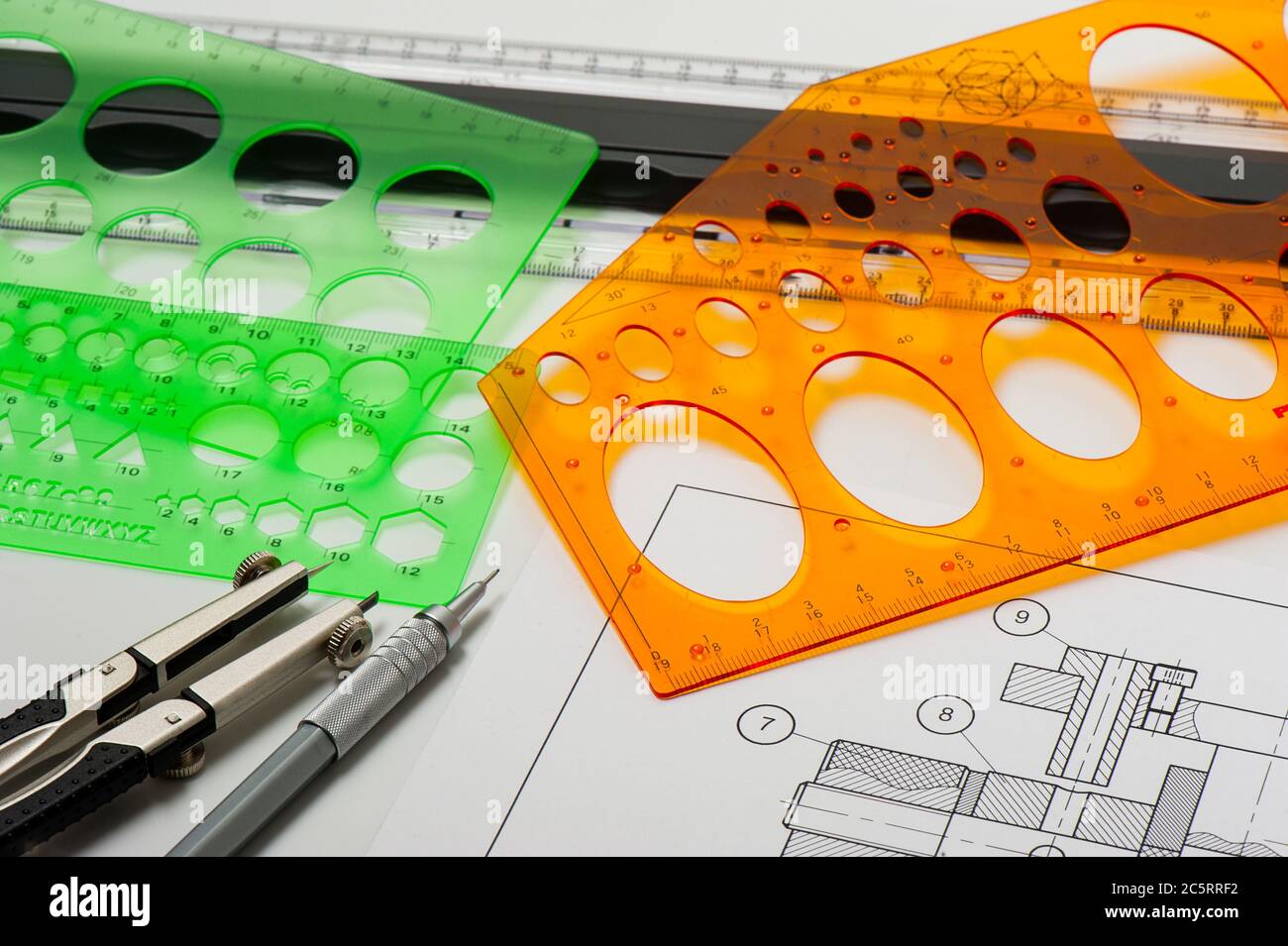 plastic technical drawing templates on engineer's desktop, tool for ...