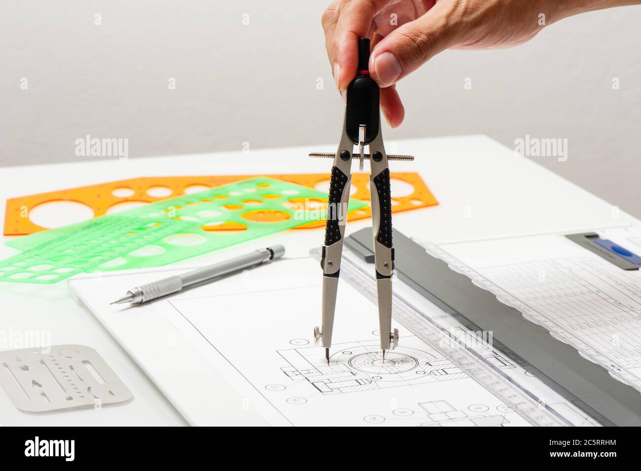 closeup technician's hand while using the industrial drawing tools ...