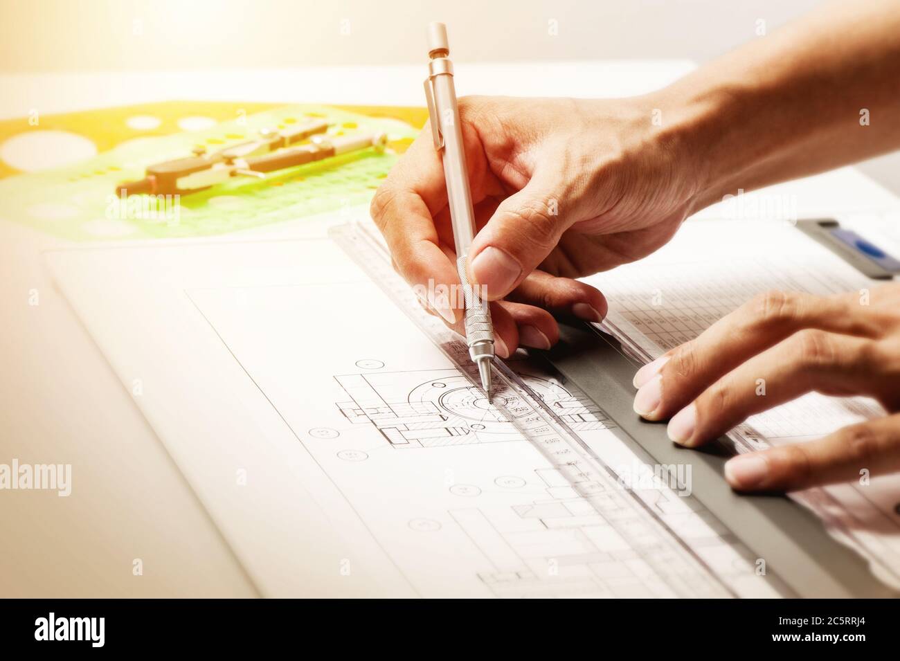 closeup technician's hand while using the industrial drawing tools ...