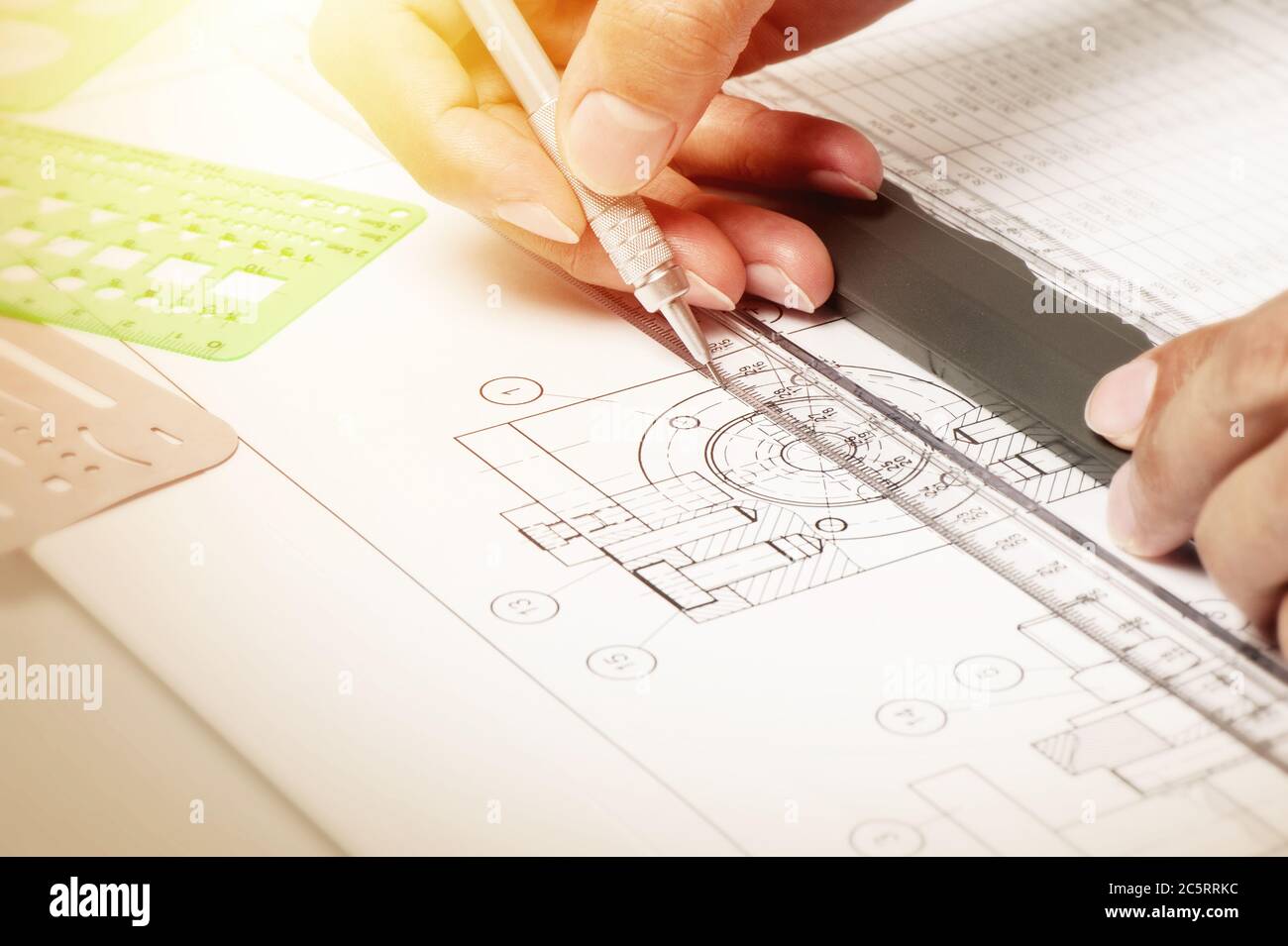 closeup technician's hand while using the industrial drawing tools ...