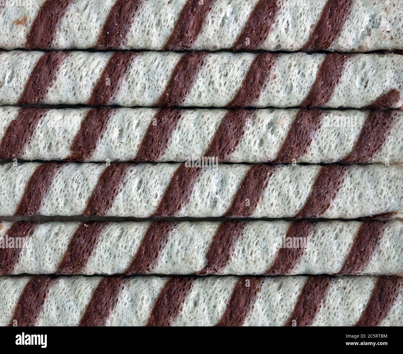 A closeup of chocolate striped wafer rolls Stock Photo - Alamy