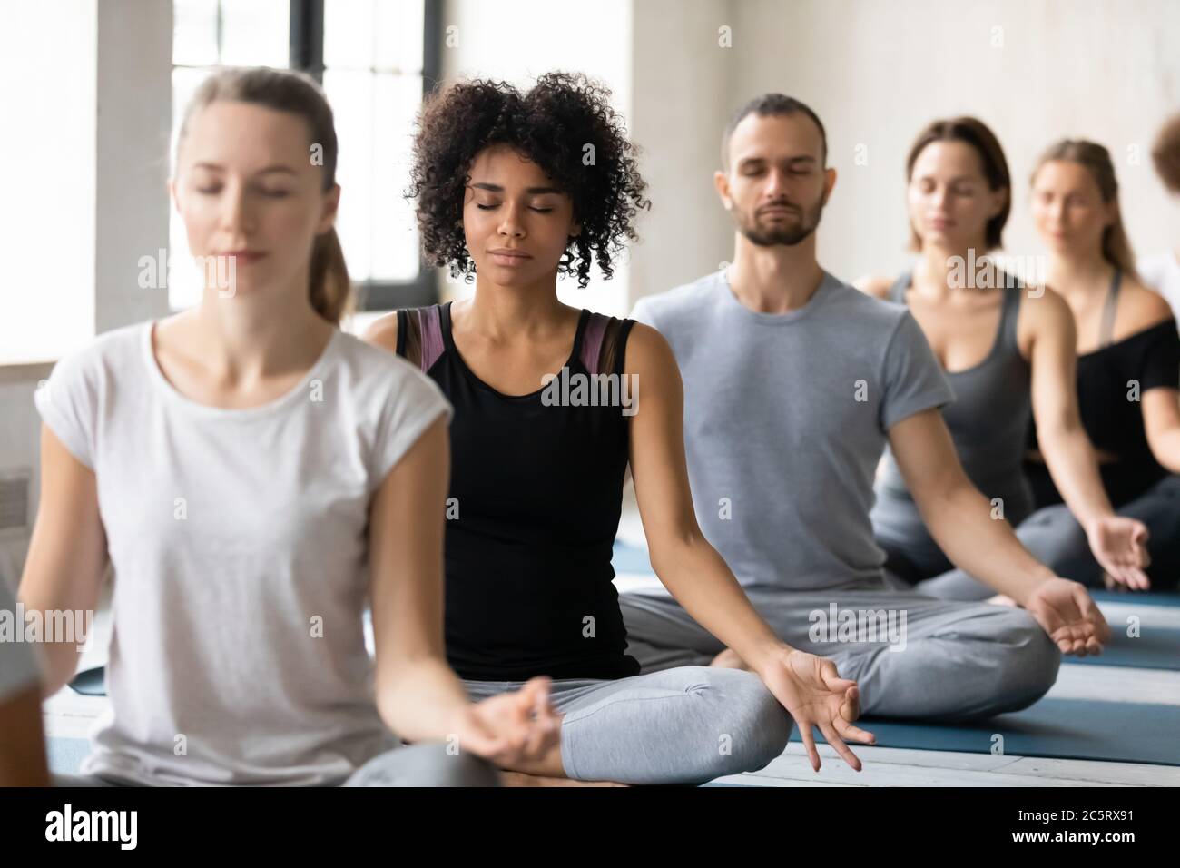 Young beautiful peaceful african american woman meditating with diverse ...