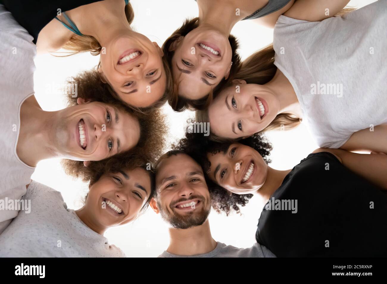 Smiling beautiful mixed race people touching heads in circle Stock ...