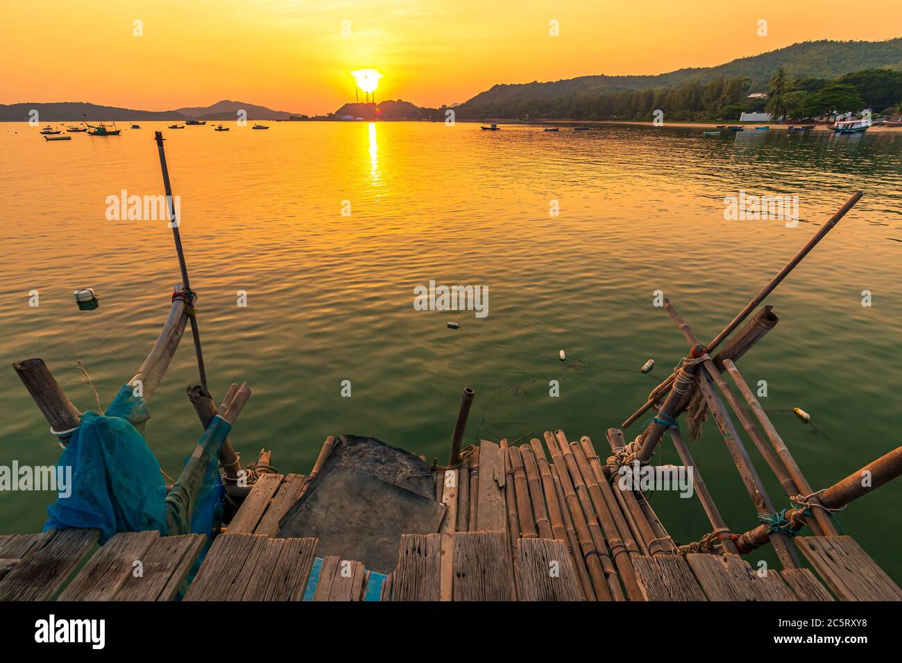 Wooden dock in the sea at sunset Stock Photo - Alamy