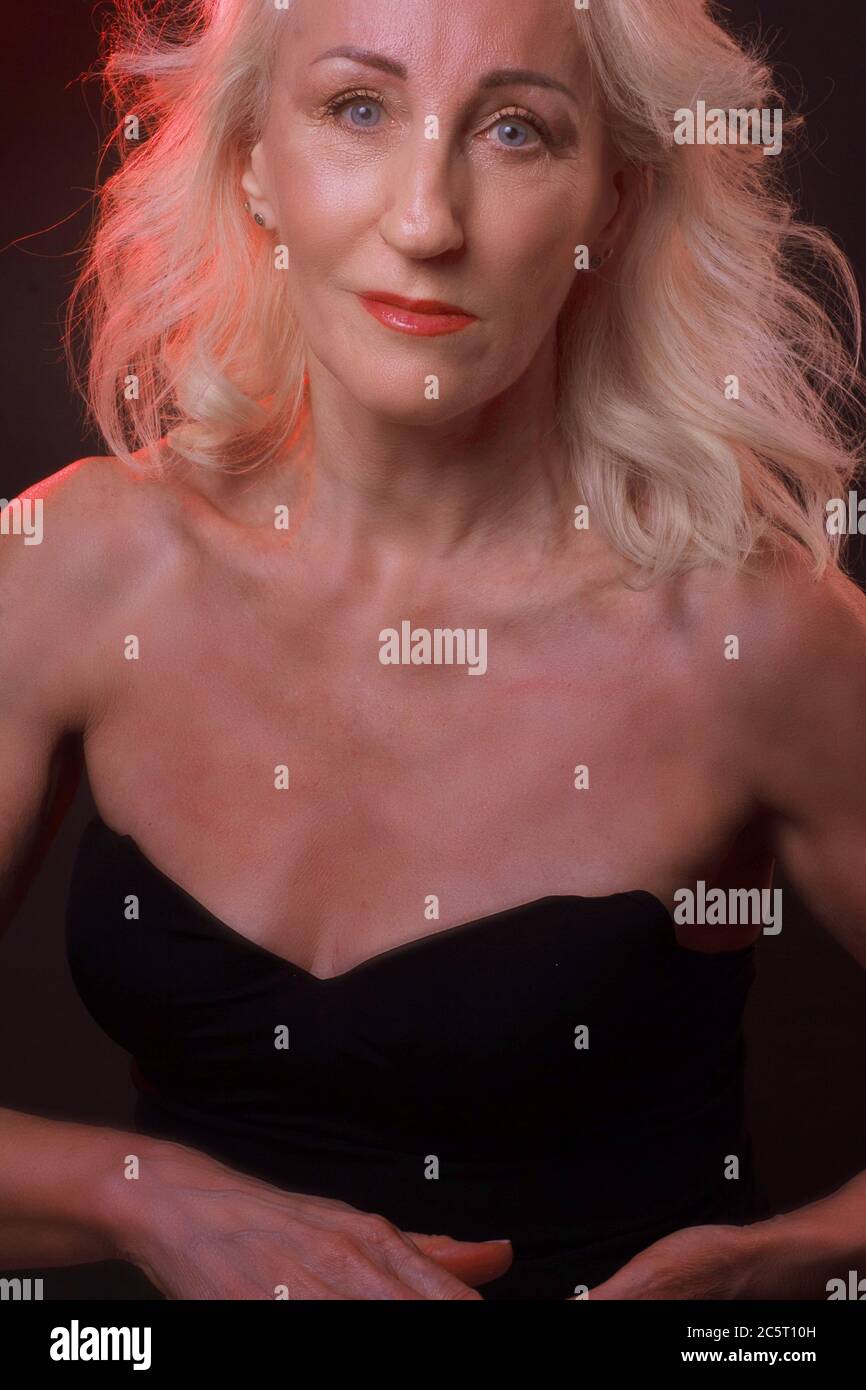 Portrait Old Woman In A Black Dress With Straps In Colorful Bright
