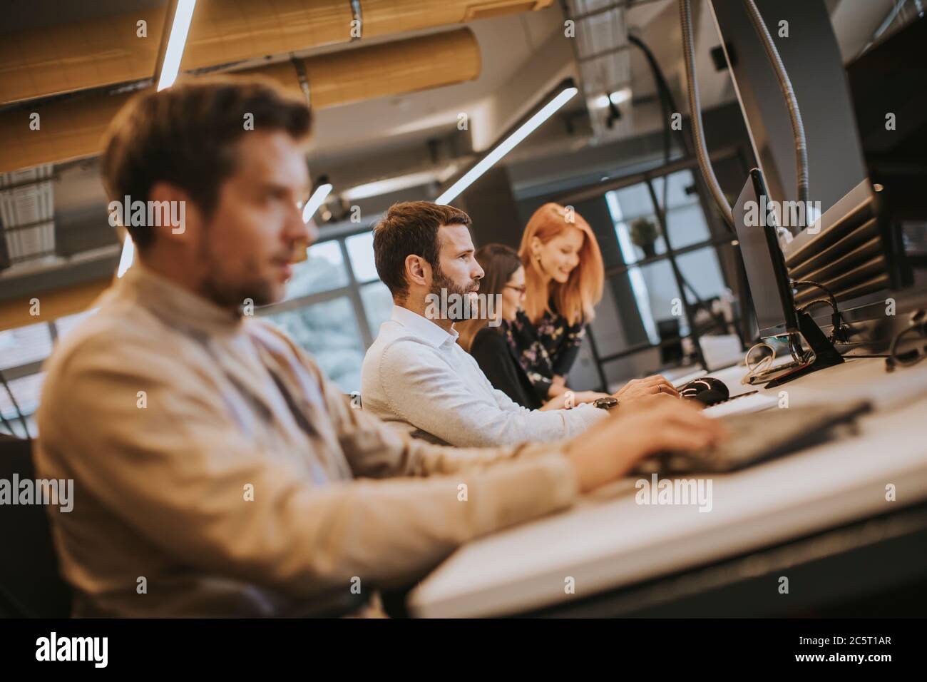 Handsome young professional businessman uses a computer for work in the ...
